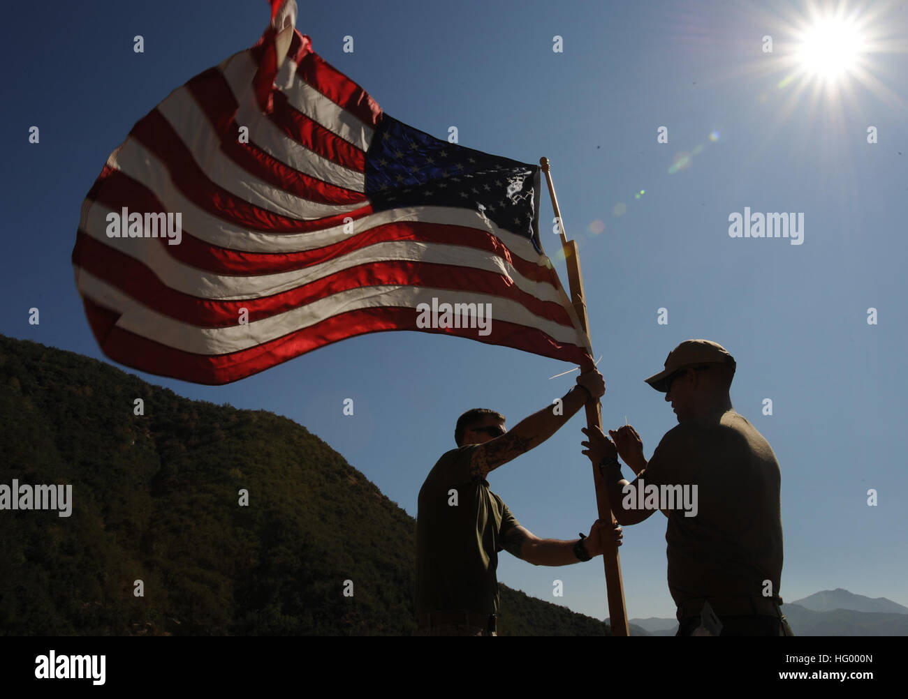 Hospital Corpsman 2nd Class and combat camera personnel raise the ...