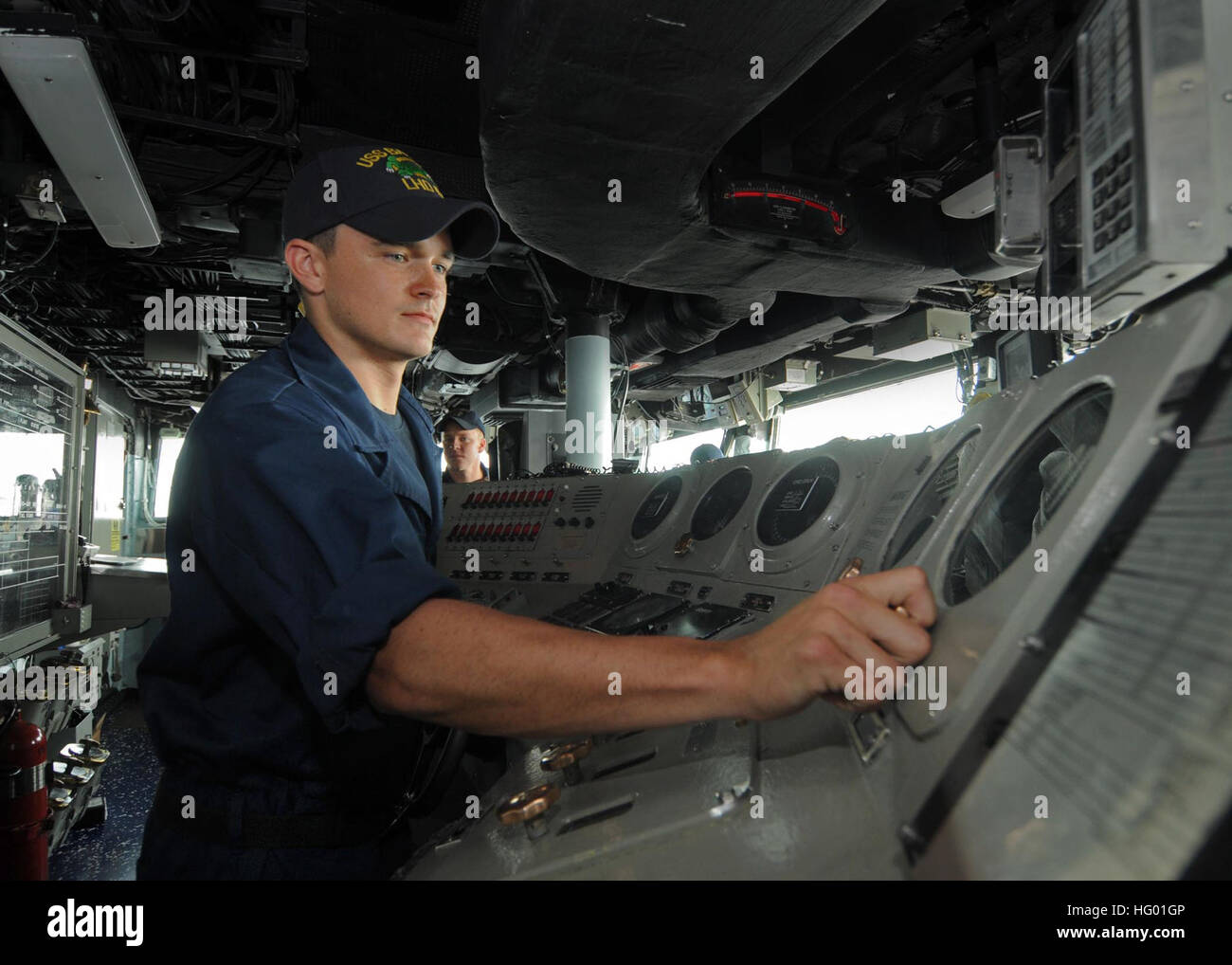 Aboard the amphibious assault ship USS Bataan, a seaman serves as ...