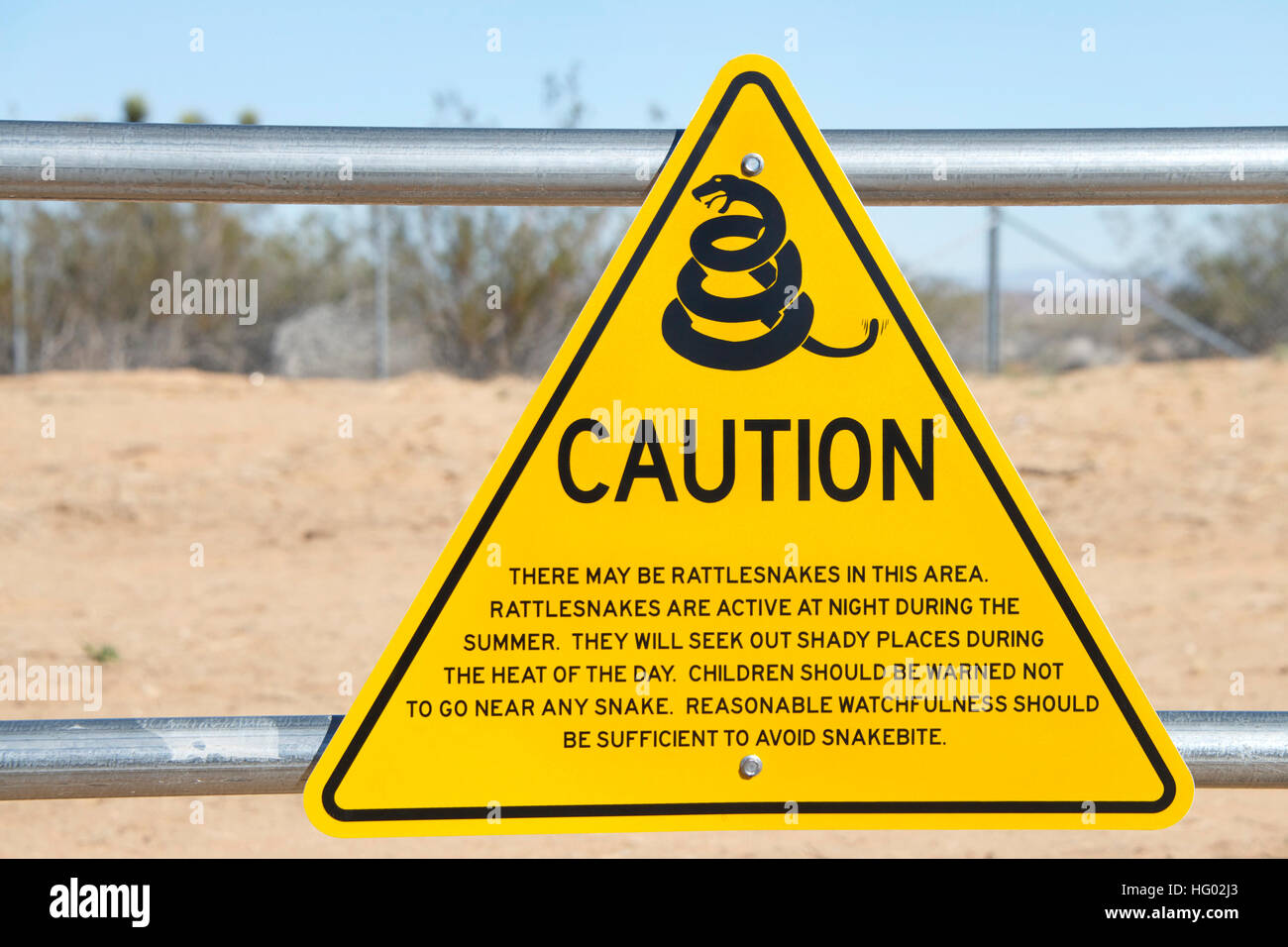 A yellow triangle sign with Snake caution warning at a rest top in the ...