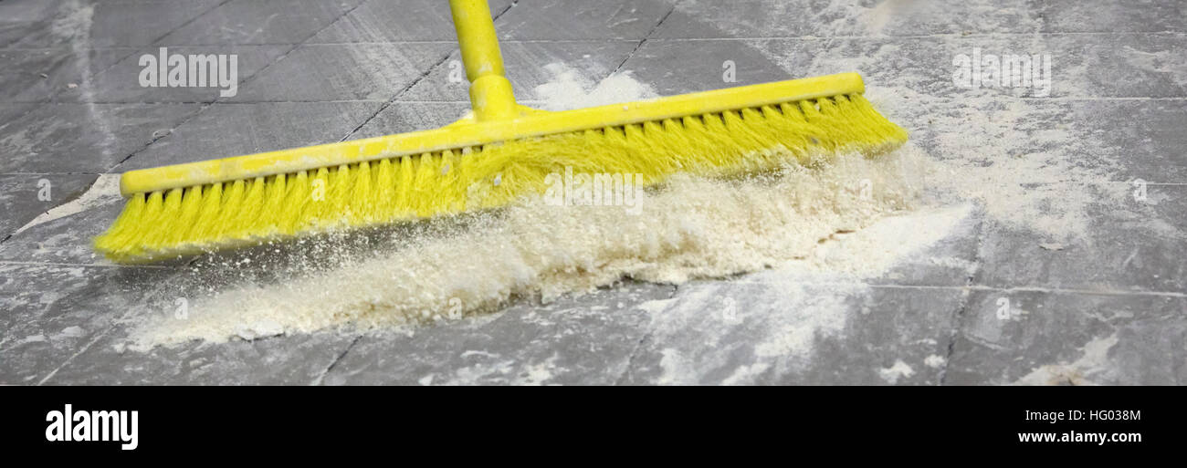 Sweeping the bakery floor from flour residue Stock Photo - Alamy