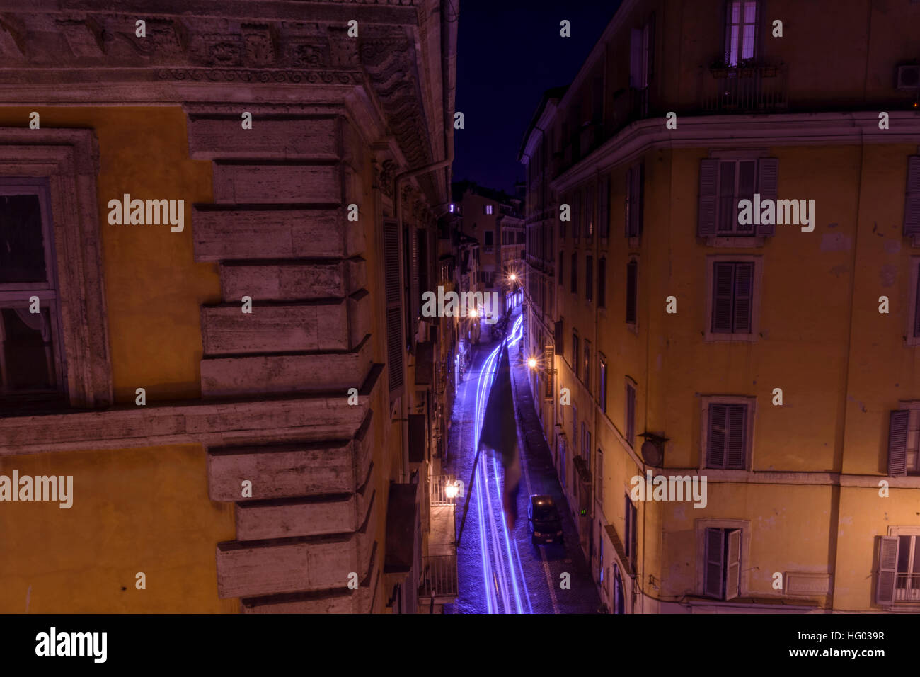 Night time view between two narrow buildings in Rome, Italy Stock Photo ...