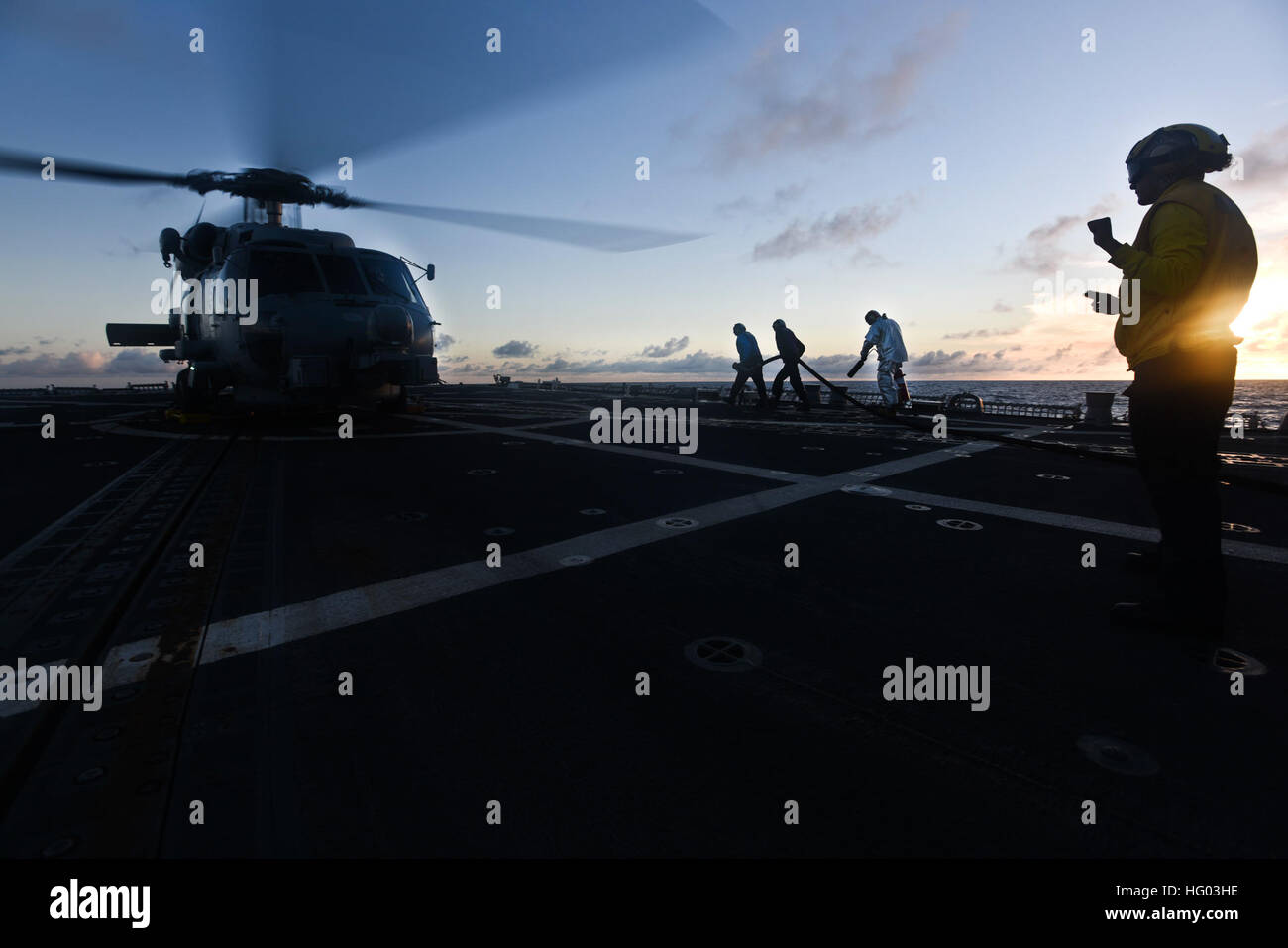 Sailors aboard USS Shoup refuel an MH-60R Sea Hawk helicopter attached ...
