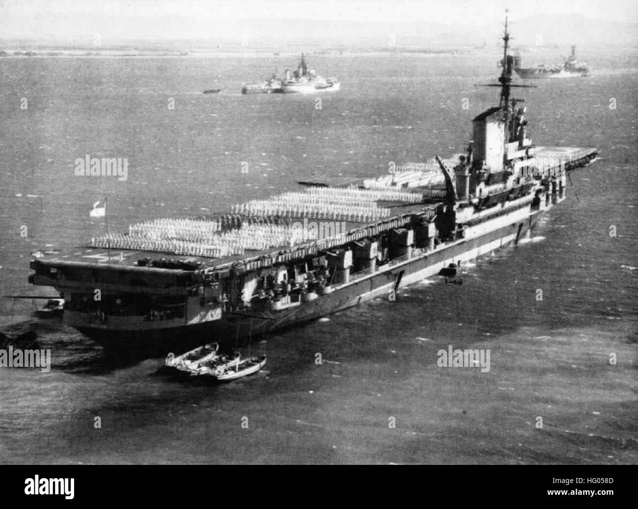 Aircraft carrier USS Coral Sea (CVB-43) anchored offshore, displaying ...