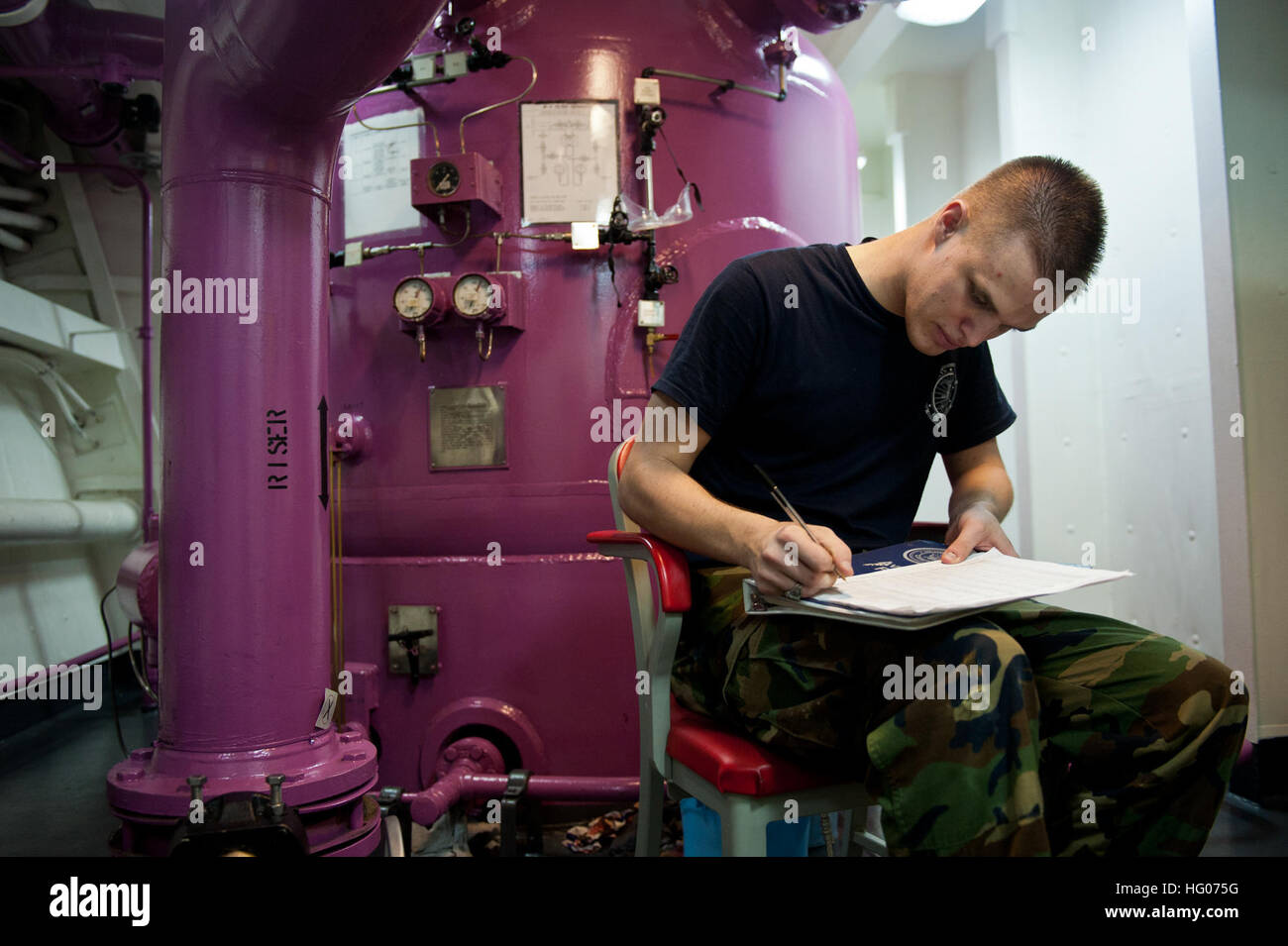 An Aviation Boatswain's Mate (Fuel) logs fuel pressure during fuel ...