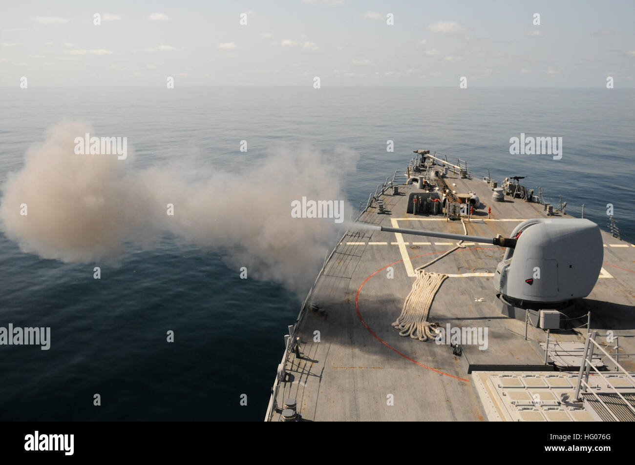 USS Mitscher (DDG 57) fires its MK-45 5-inch/54-caliber gun during a ...