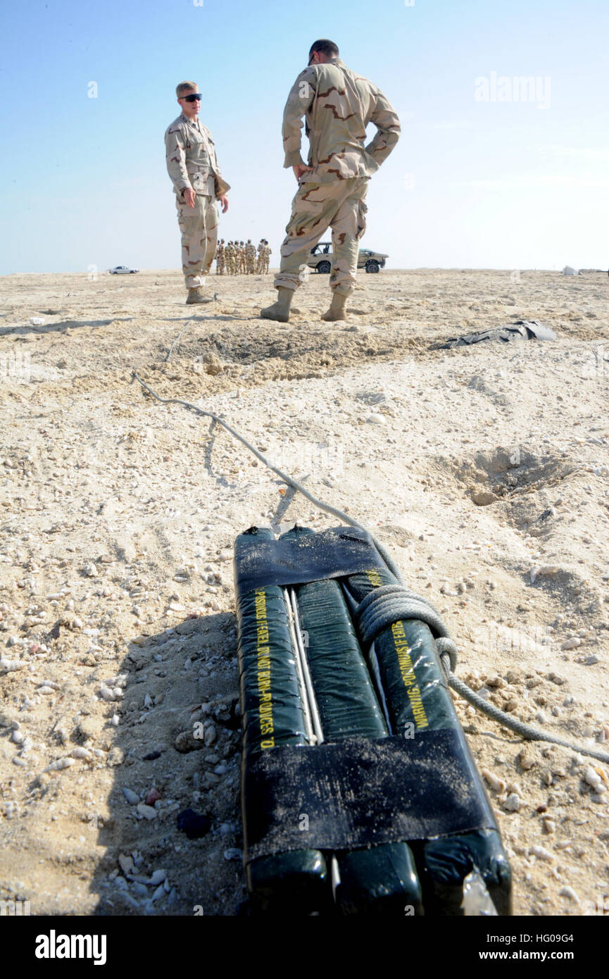Explosive ordnance disposal technicians prepare explosives for a ...