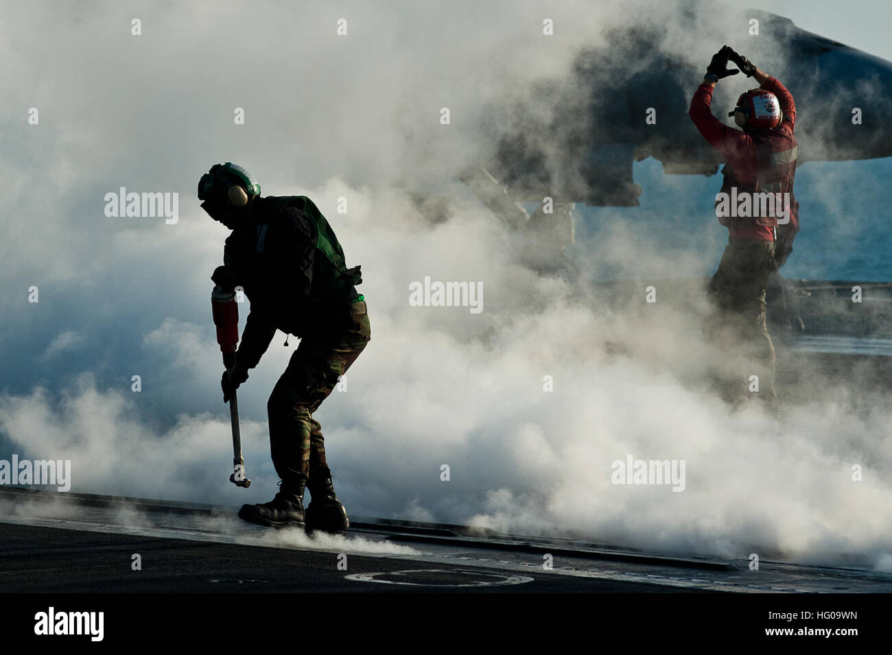 A Sailor retrieves a hold back bar during flight operations aboard USS ...