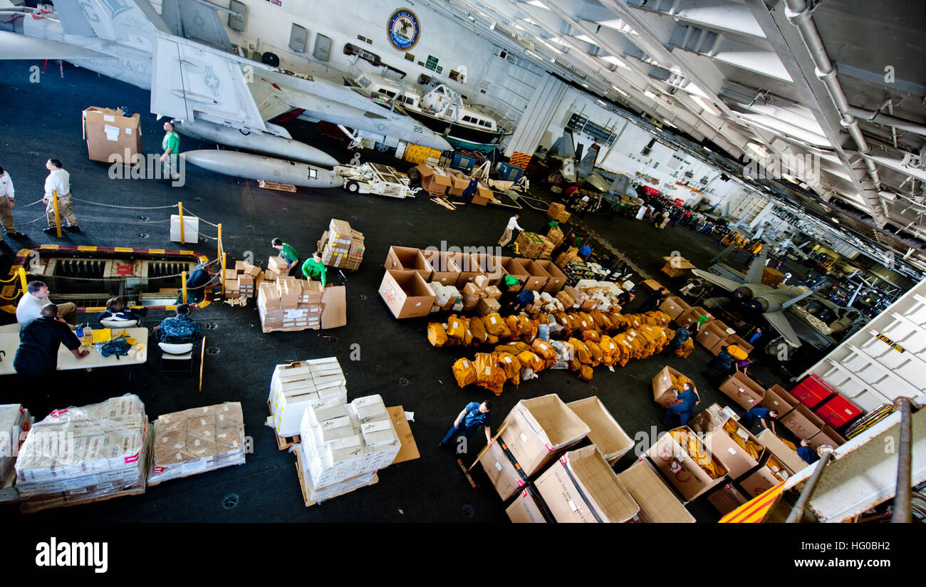 111221-N-OY799-418 ARABIAN GULF (Dec. 21, 2011) Sailors sort cargo in ...
