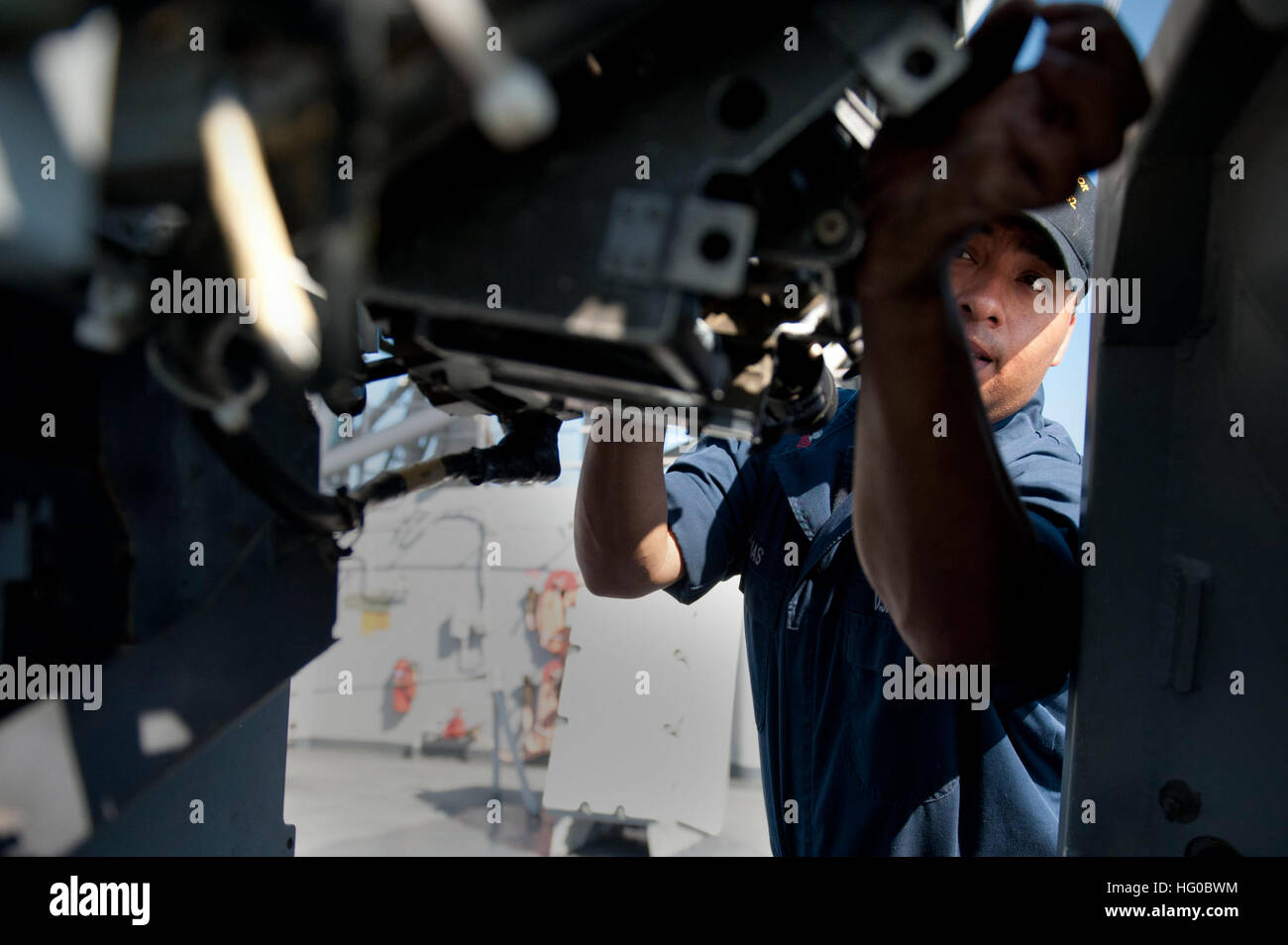 A Gunners Mate aboard the amphibious dock landing ship USS Pearl Harbor ...