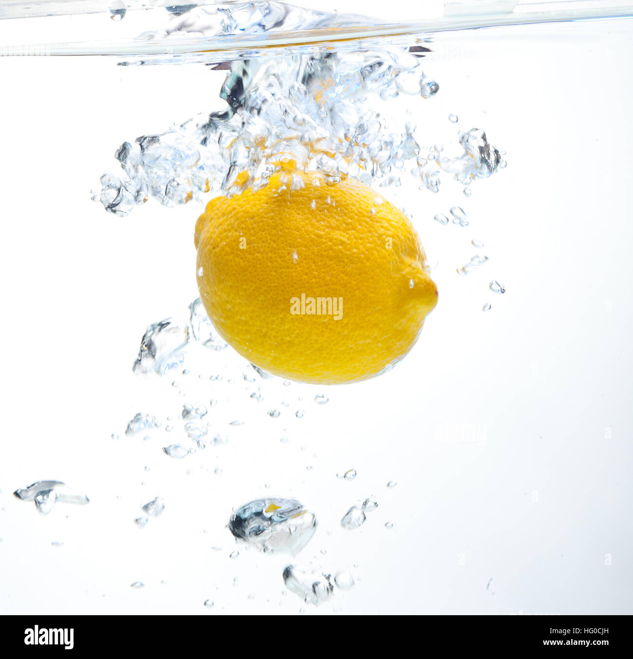 Lemons floating in the water on a white background Stock Photo - Alamy