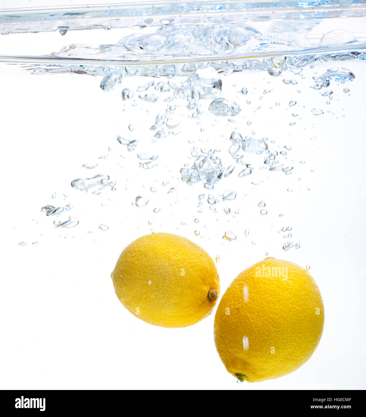 Lemons floating in the water on a white background Stock Photo - Alamy