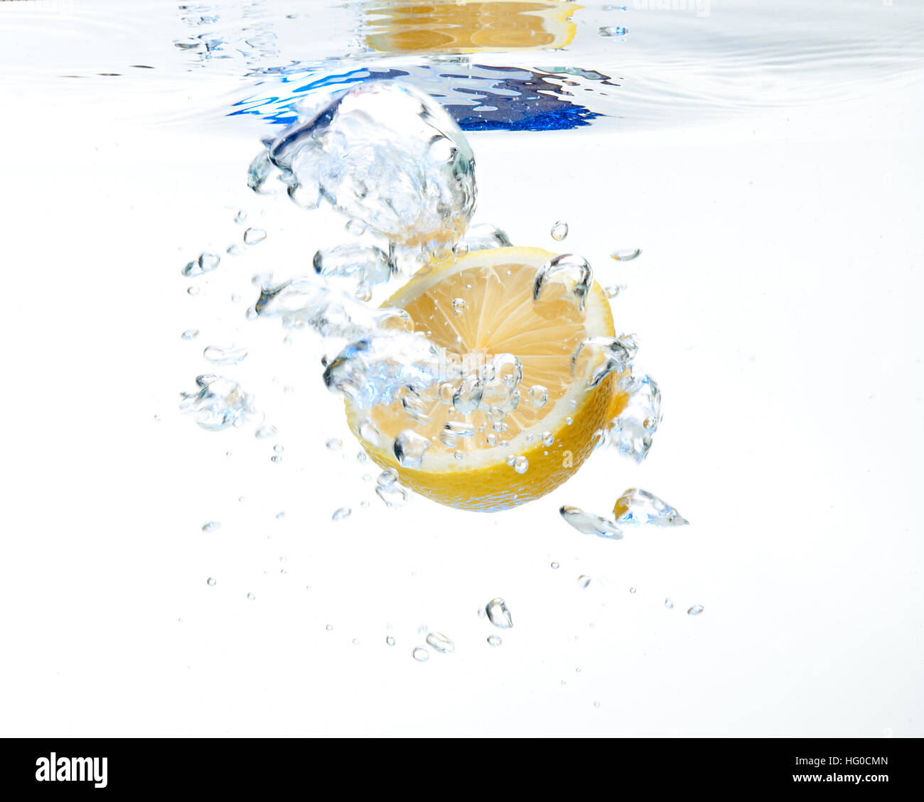 Lemons floating in the water on a white background Stock Photo - Alamy