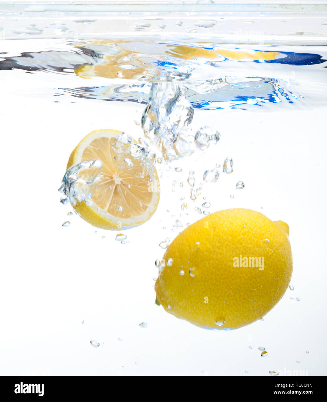 Lemons floating in the water on a white background Stock Photo - Alamy