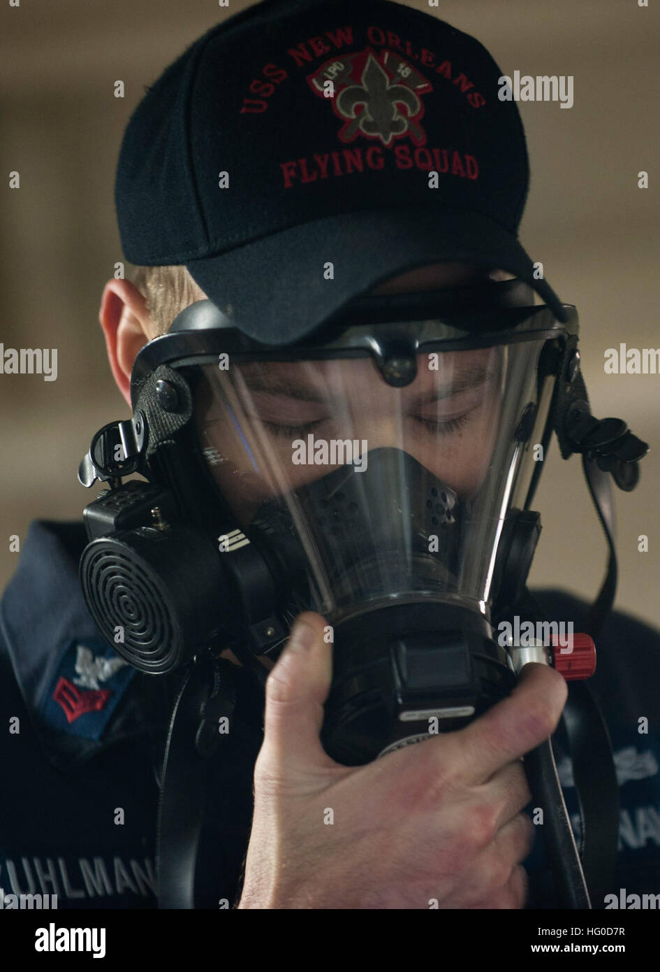 Damage Controlman 1st Class demonstrates how to properly don a ...