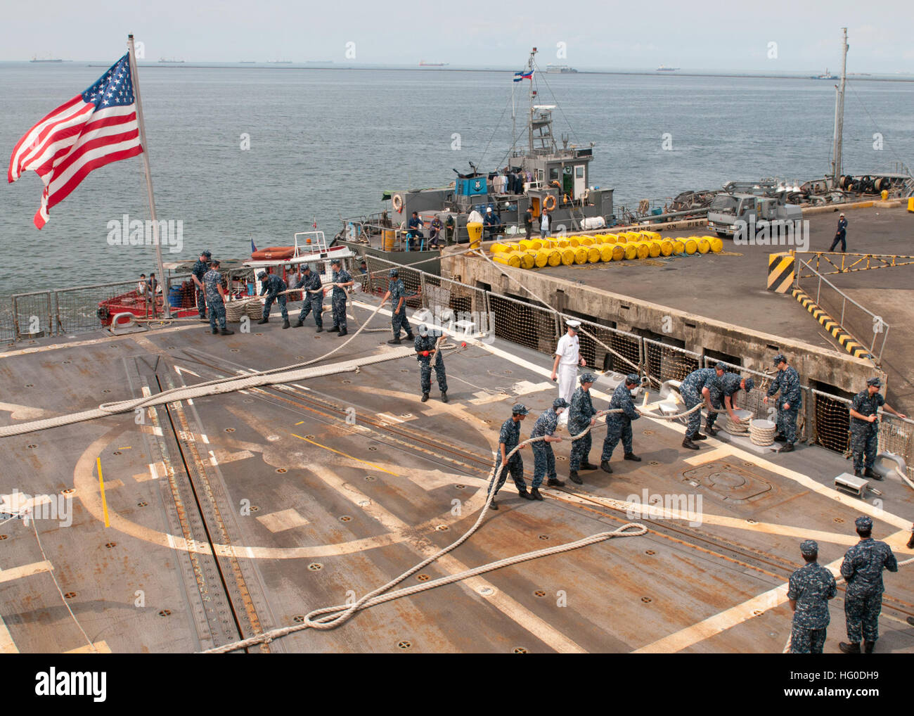 Sailors secure mooring lines as the guided-missile destroyer USS Wayne ...