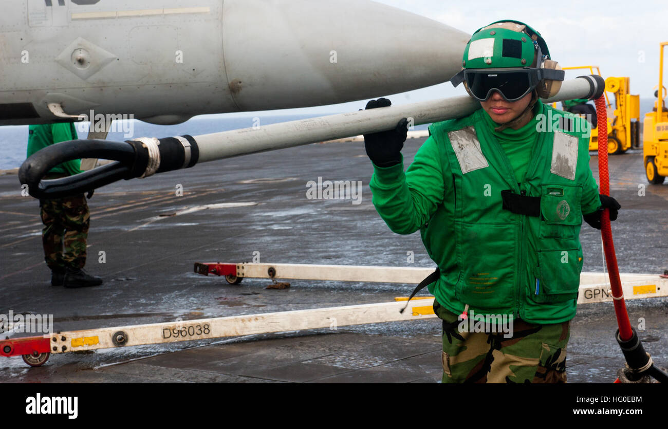 A Logistics Specialist aboard USS John C. Stennis carries a cargo hook ...
