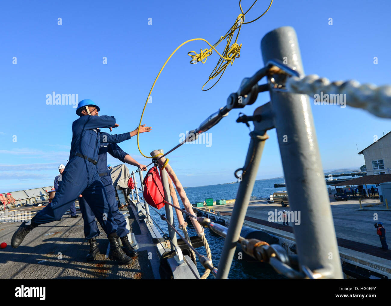 U.S. Navy Seaman Apprentice Brandon Archibald heaves a line from the ...