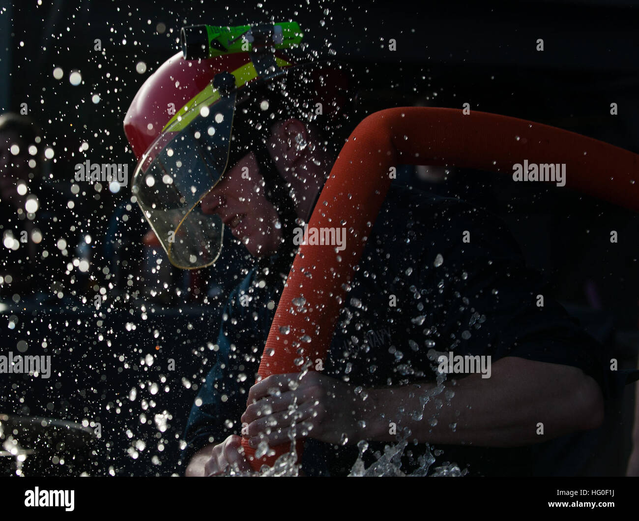 A sailor drains barrels of water while competing in the de-watering ...