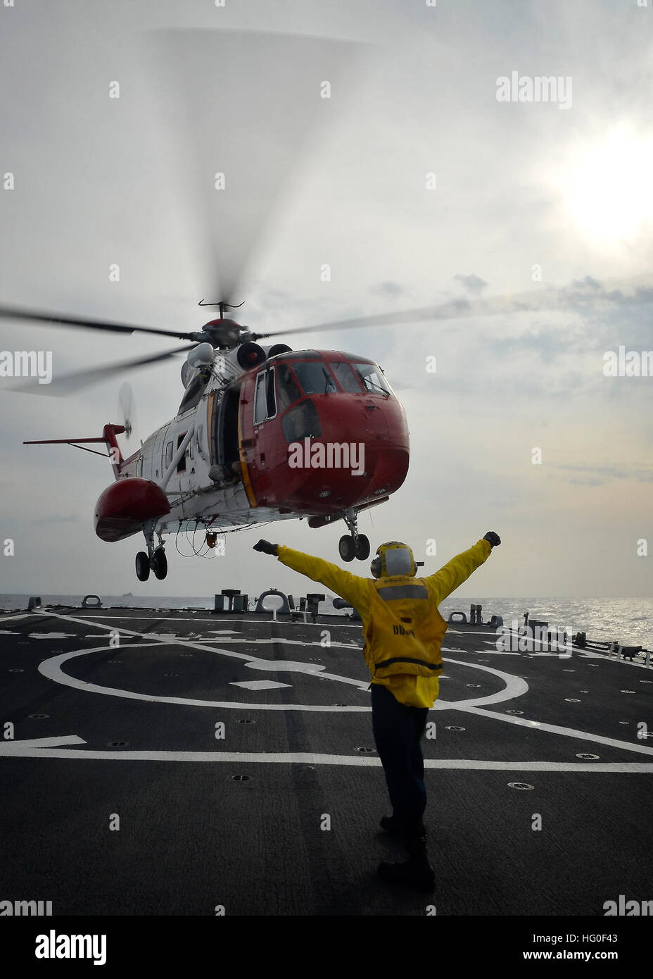 Boatswain's Mate Seaman Gerald Dekle guides a Sikorsky S-61N twin ...