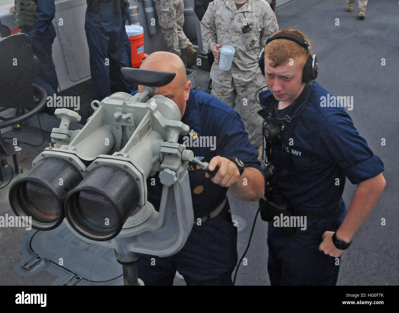 Command Master Chief Rafael Perez looks through the big eyes on the ...