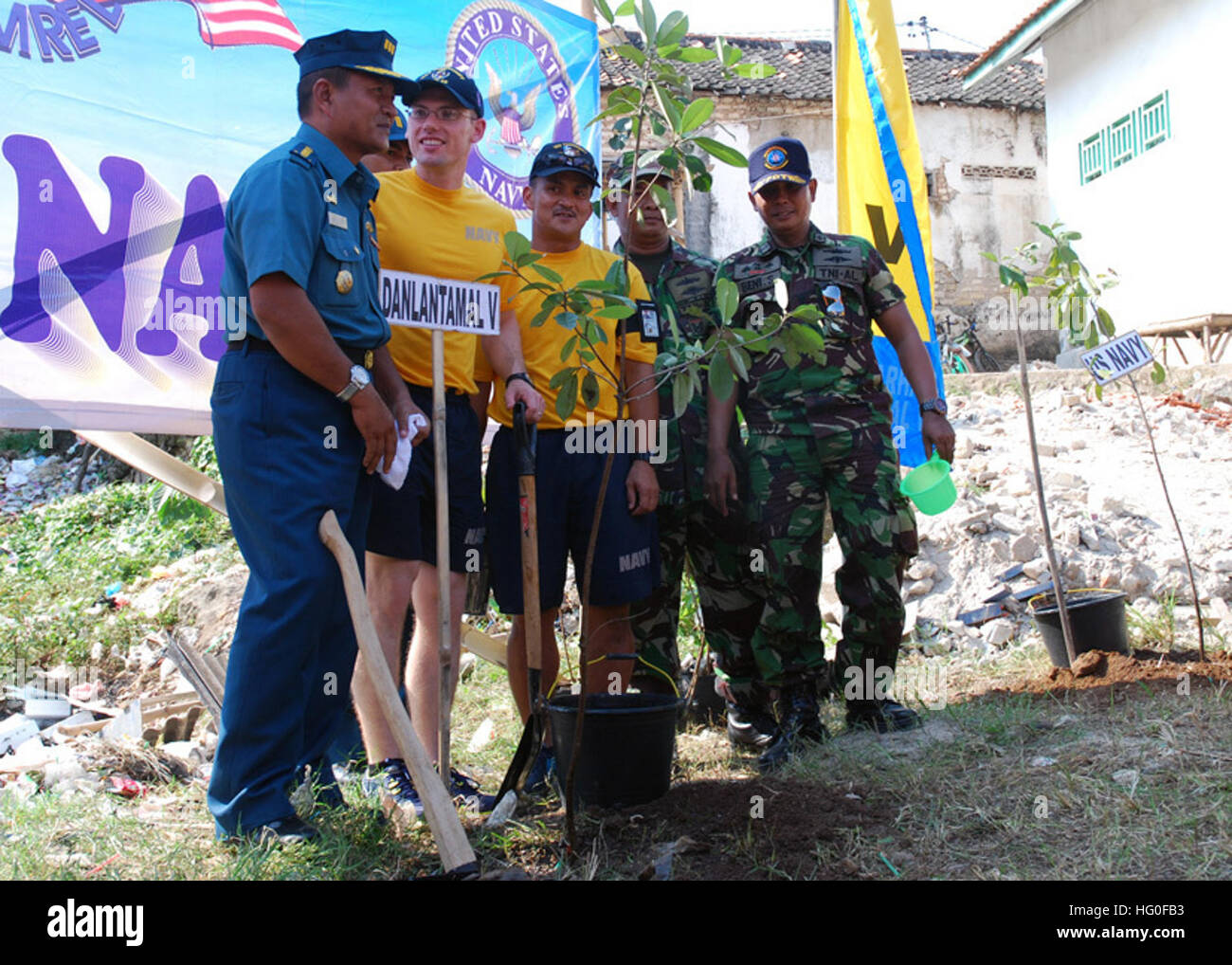 U.S. and Indonesian sailors plant a tree at Kwanyar Village School ...