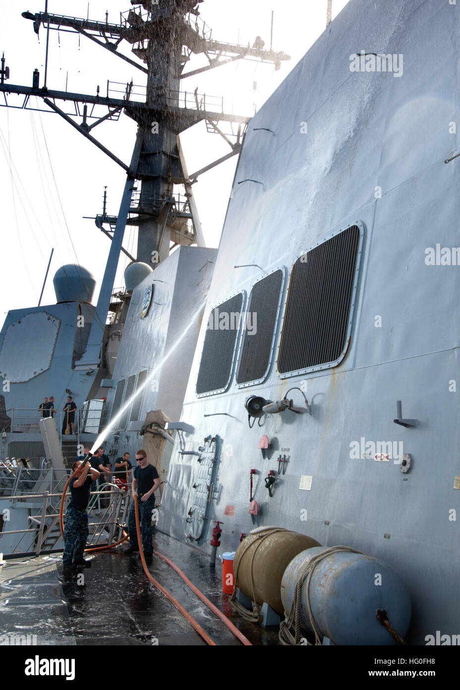 Sailors participate in a fresh-water washdown aboard the guided-missile ...
