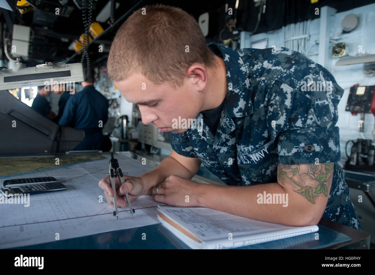 Quartermaster Seaman Brandon Flores, from San Antonio, plots a fix from ...
