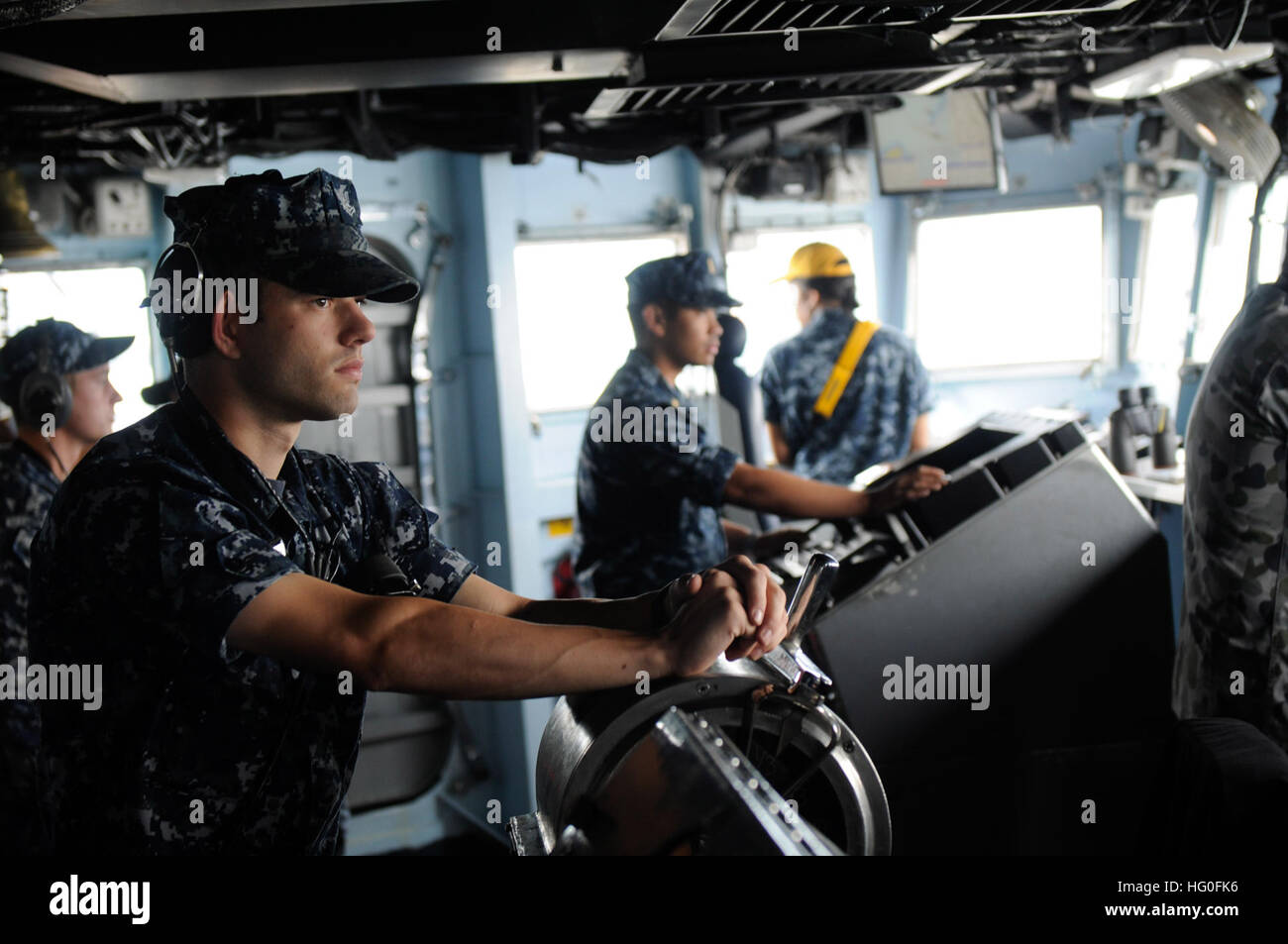 Boatswain's Mate 2nd Class Bryant Sheridan operates the helm aboard U.S ...