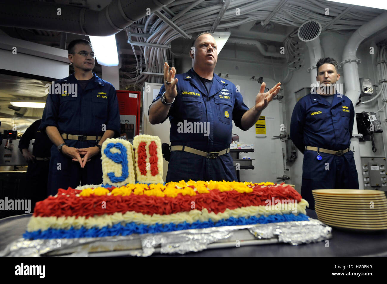 U.S. Navy Cmdr. David Bretz, left, the commanding officer of the guided ...