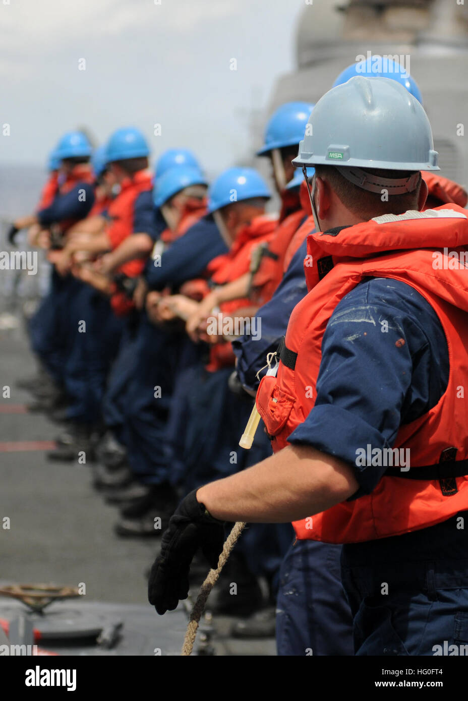Sailors handle lines as the Oliver Hazard Perry-class guided-missile ...
