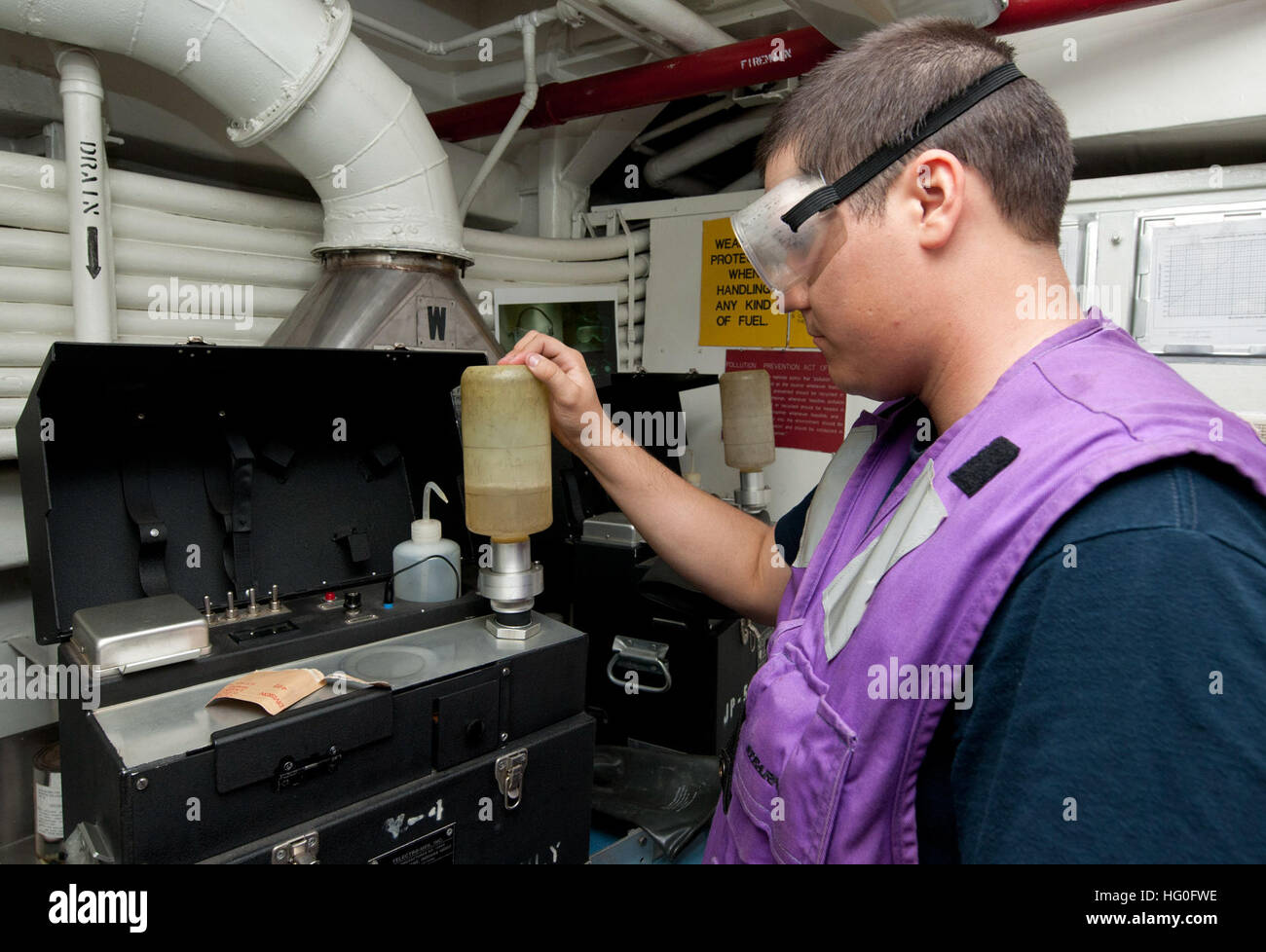 U.S. Navy Aviation Boatswain's Mate Fuel 3rd Class Ben Moran pours fuel ...