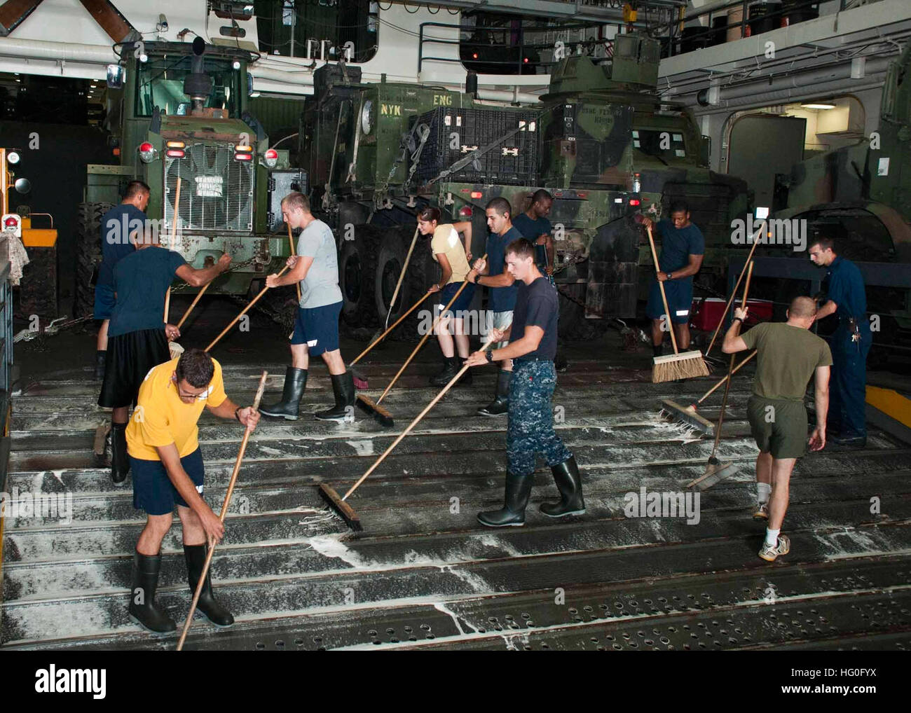 USS New York (LPD 21) crew and Marines clean the vehicle stowage area ...
