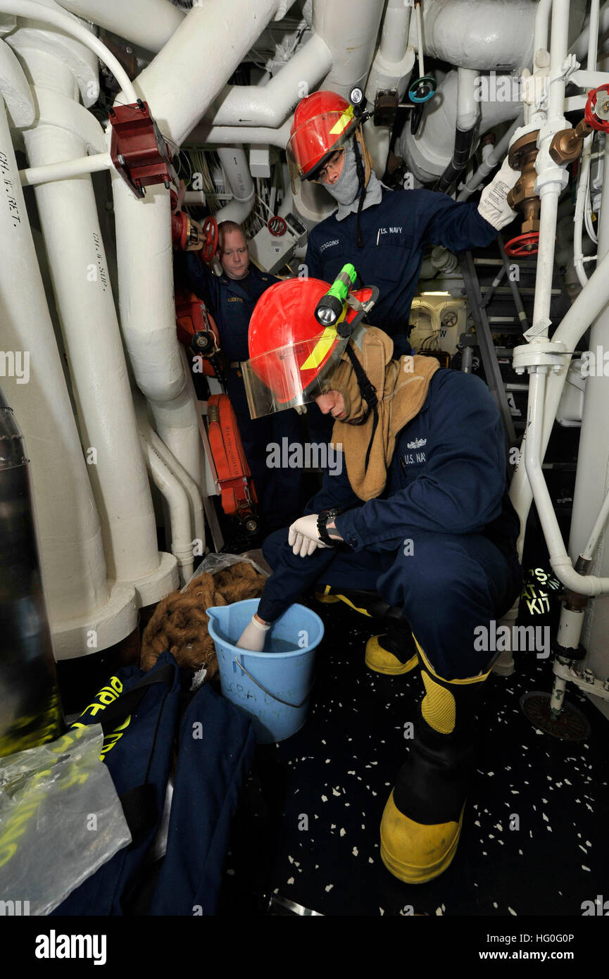 Hull Maintenance Technician Fireman Justin Turner activates an ...