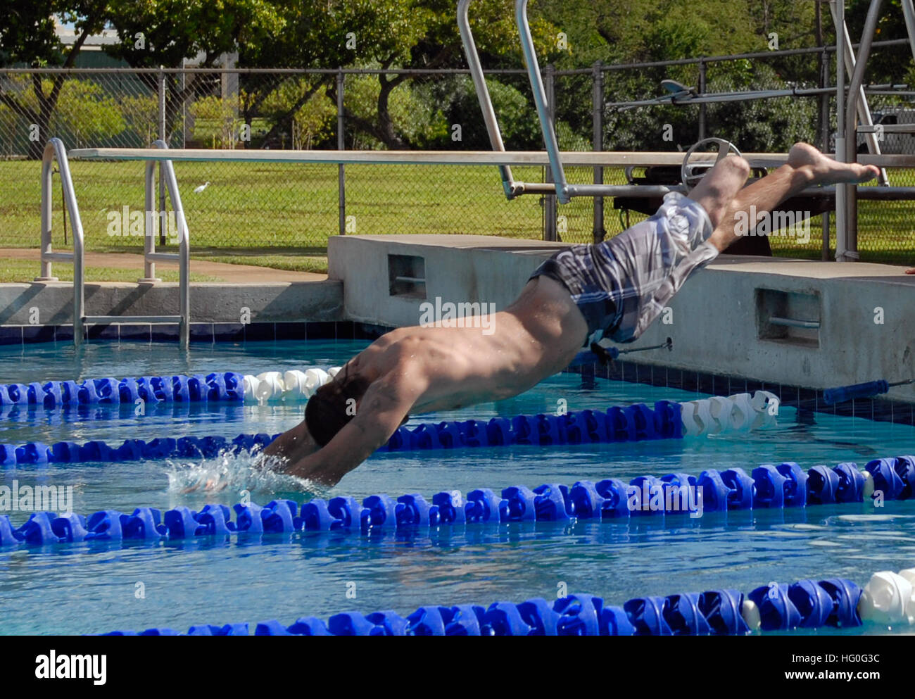 U.S. Navy Hospital Corpsman 3rd Class Redmond Ramos dives into a pool ...