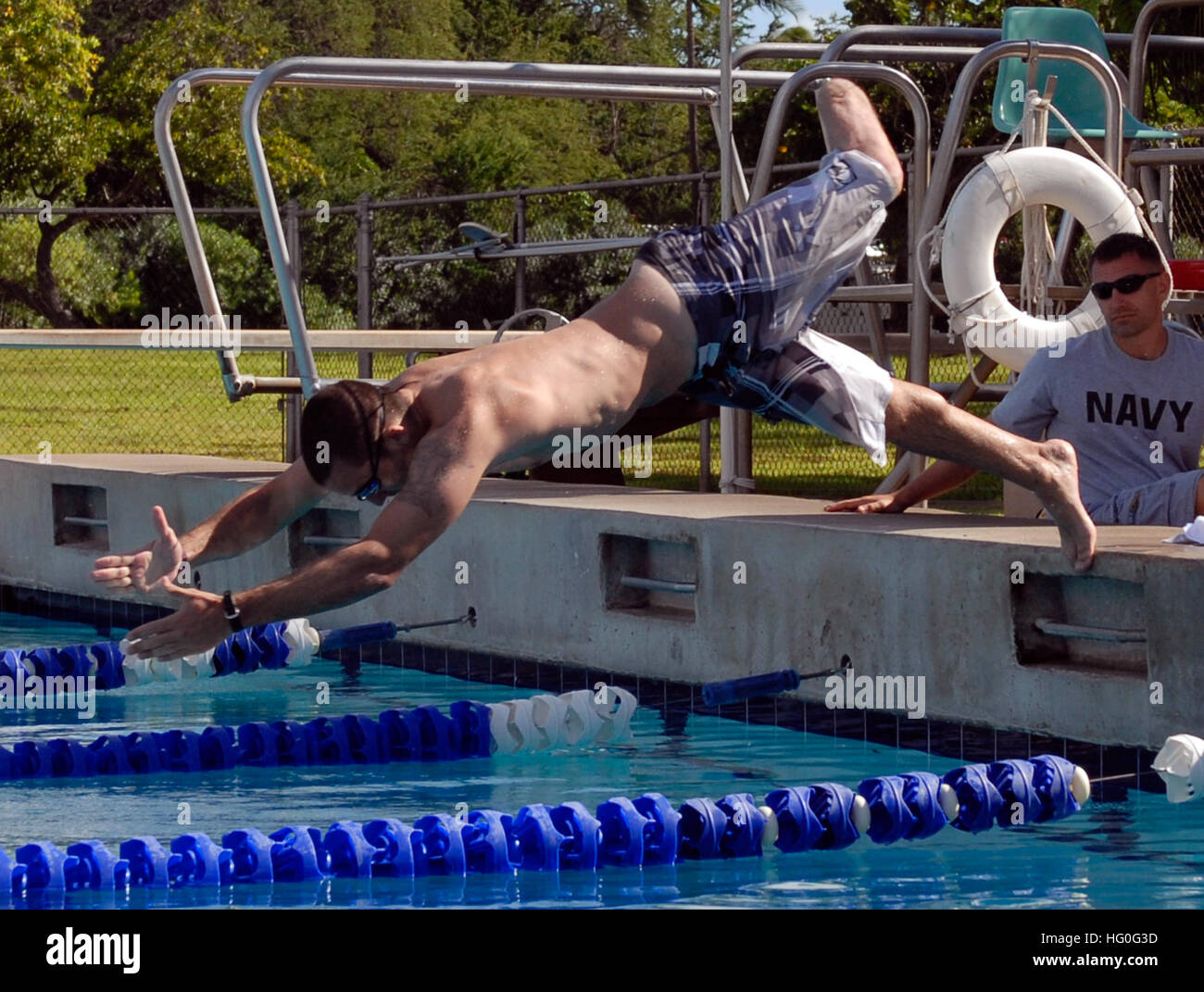 U.S. Navy Hospital Corpsman 3rd Class Redmond Ramos dives into a pool ...