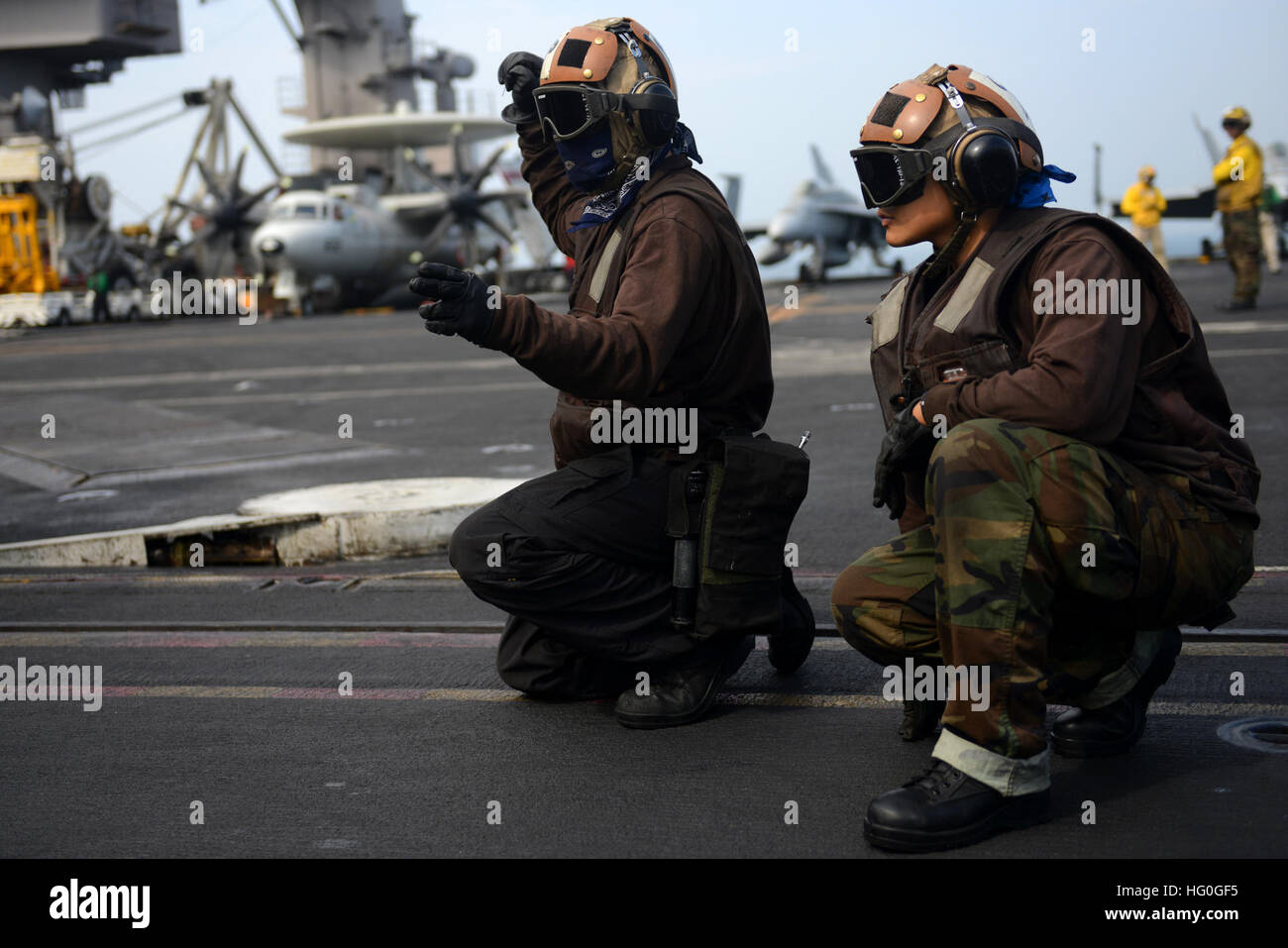 Plane captains signal for the start up of an engine prior to flight ...