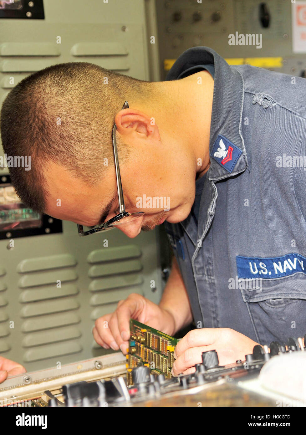 Interior Communications Electrician 2nd Class Seth Wells replaces a ...