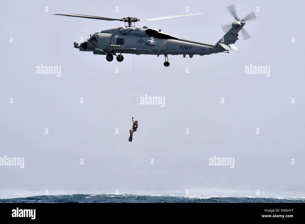 Naval Aircrewman 2nd Class Jeremiah Angerman is raised from the water ...