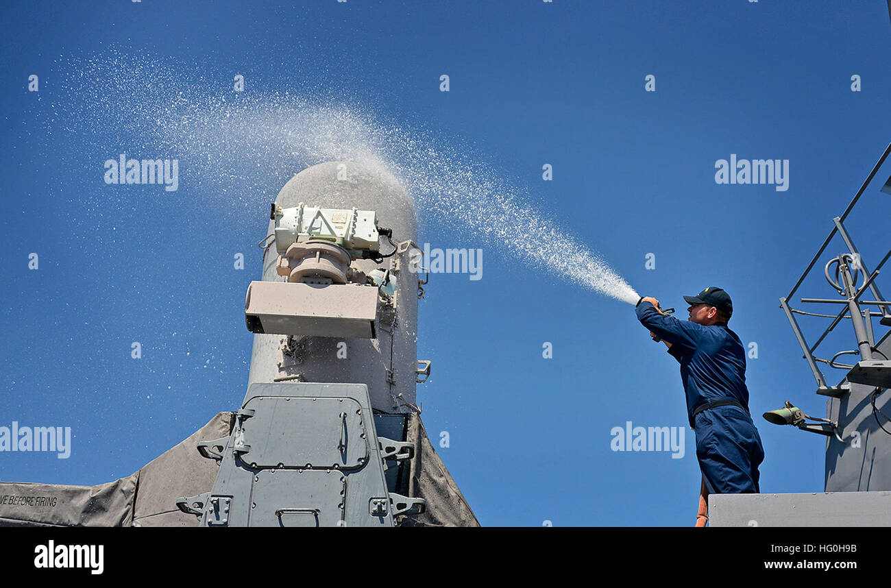 Gunner's Mate 1st Class Jared Hartung sprays water during a freshwater ...