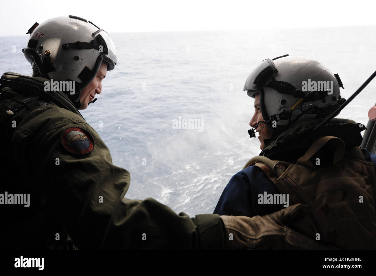 Naval Aircrewman (Helicopter) 2nd Class Dustin Kirk, left, explains ...