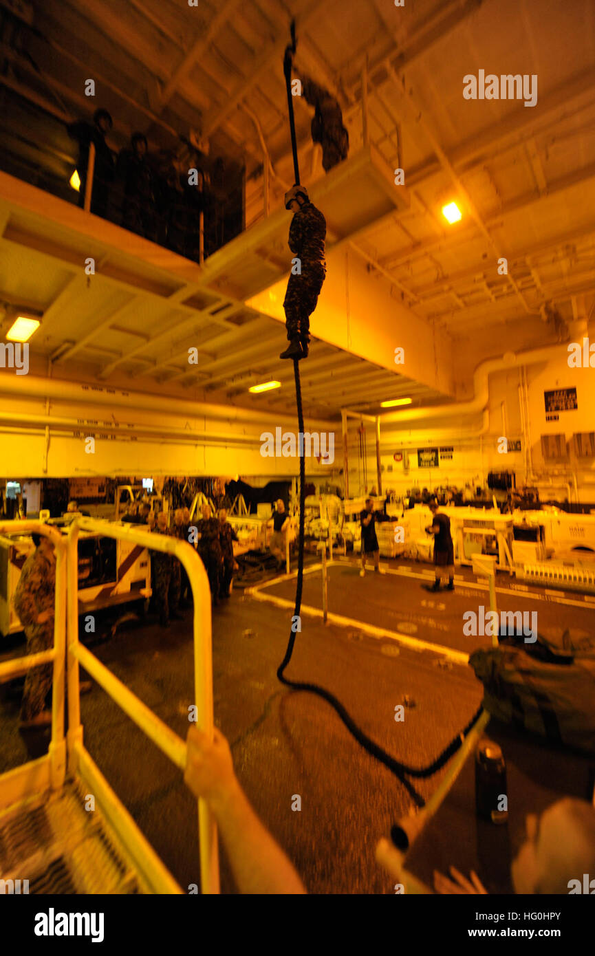 A midshipman practices a fast-roping technique as part of an explosive ...