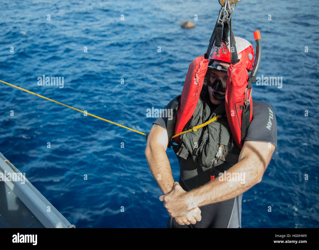 Search and rescue swimmer Quartermaster 2nd Class Riley Knox is lowered ...
