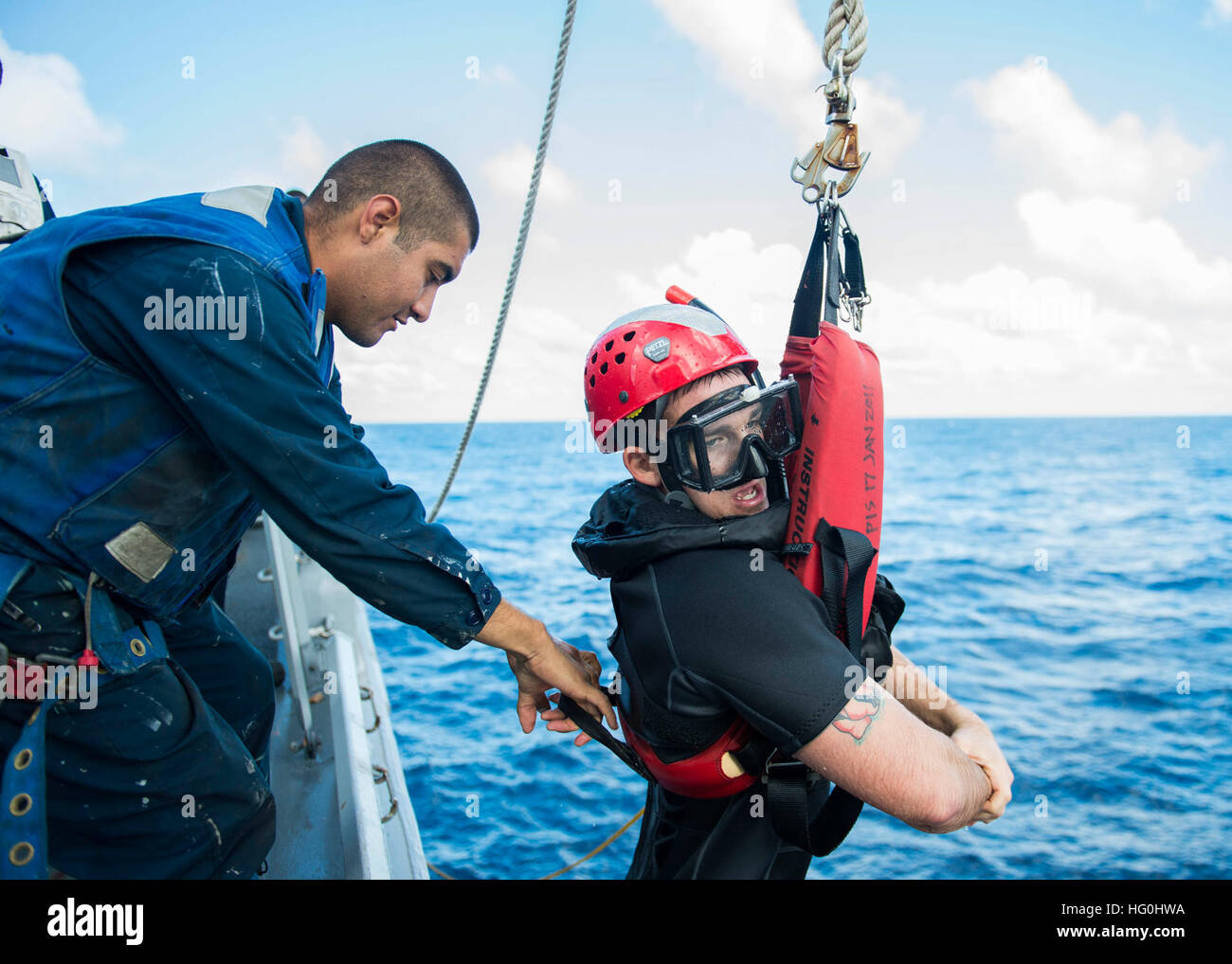 Search and rescue swimmer Quartermaster 2nd Class Riley Knox (right) is ...