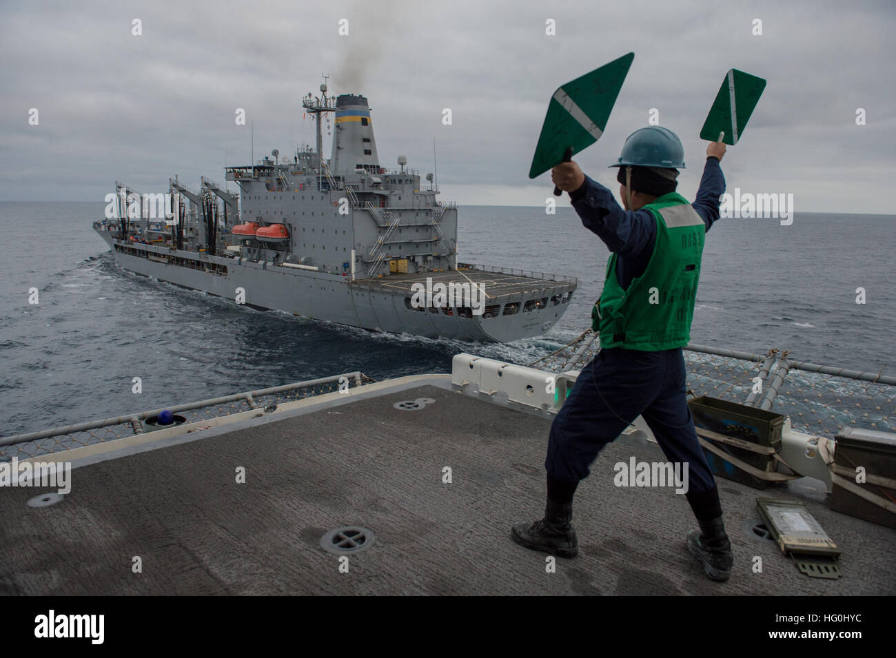 PACIFIC OCEAN (Aug. 01, 2013) Seaman Isaac Lavina signals to the bridge ...