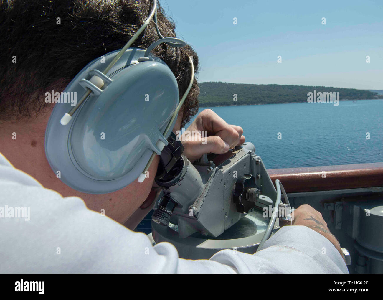 U.S. Navy Quartermaster 3rd Class Kenneth J. Curfman calculates a ...