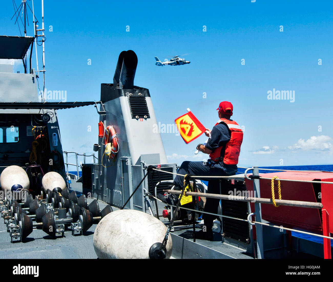 U.S. Navy Chief (select) Damage Controlman Lester Underwood signals to ...