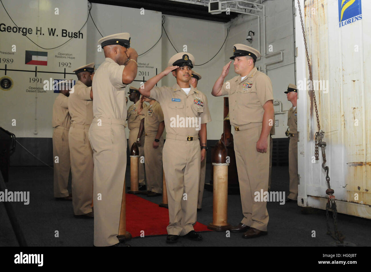 U.S. Navy Chief Electrician's Mate Daryle Urrea walks through side boys ...