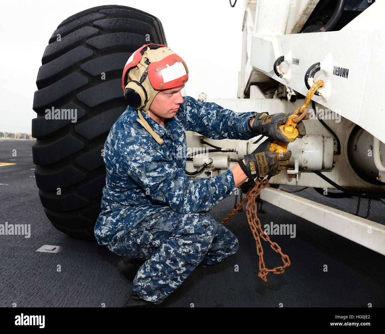U.S. Navy Aviation Boatswain's Mate (Handling) 3rd Class secures a ...