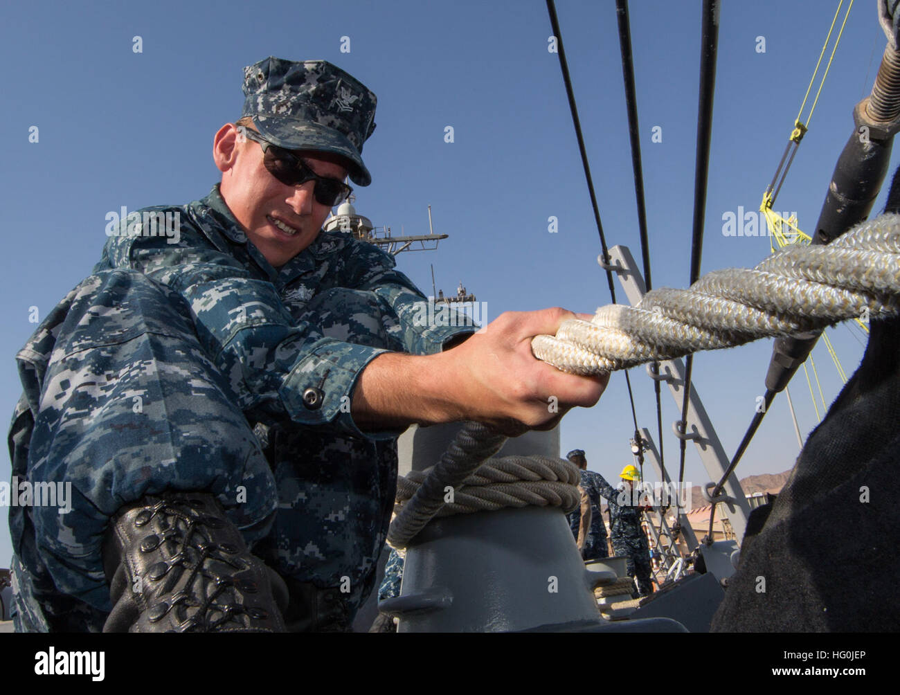 U.S. Navy Fire Controlman 2nd Class Clayton Henly heaves in a mooring ...