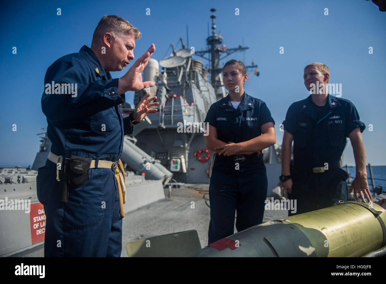 Senior Chief Gunner's Mate Louis Johnson, left, talks about procedures ...